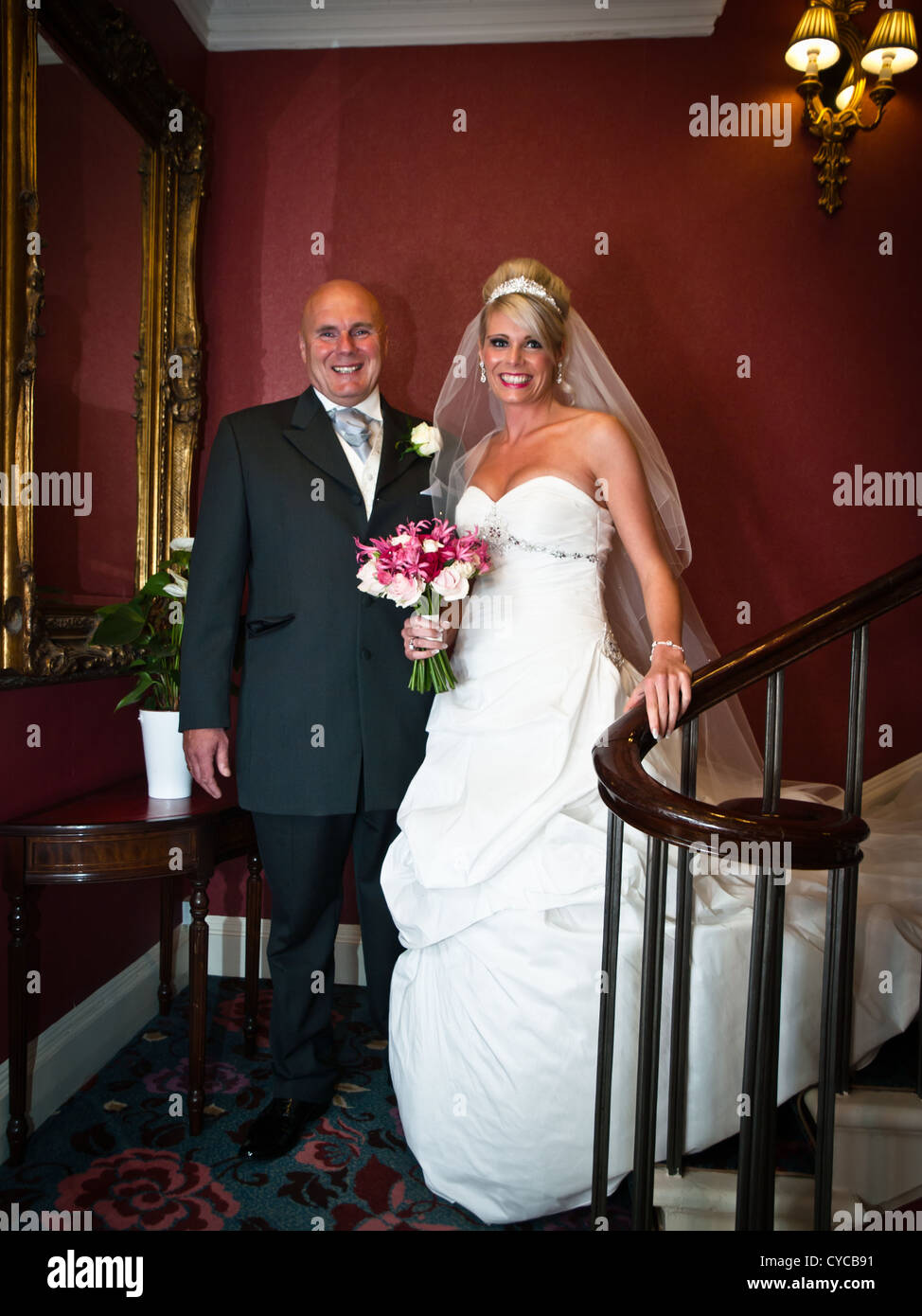 A proud father-of-the-bride poses with his daughter, the bride, on her ...