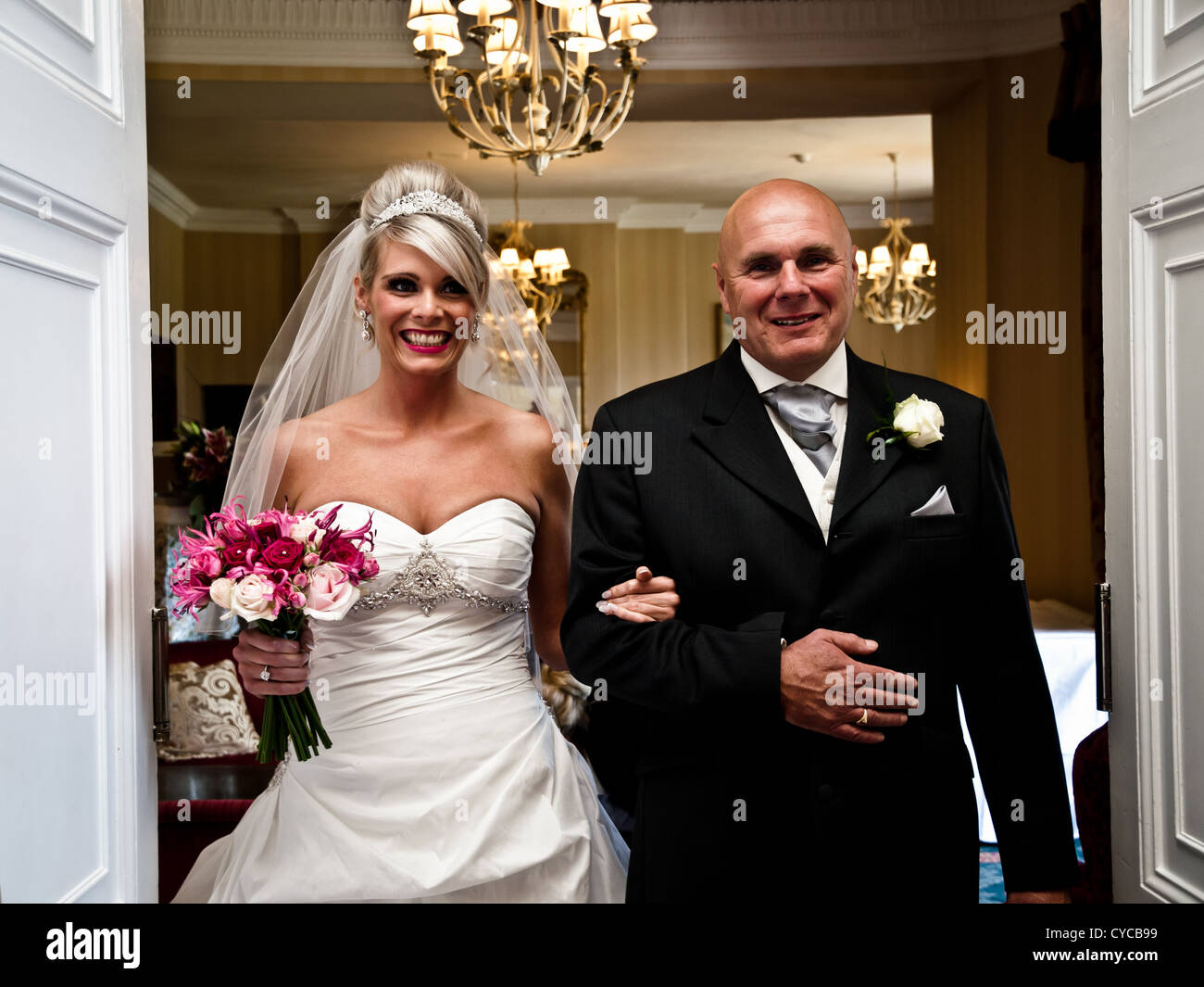 A proud father-of-the-bride prepares to walk his daughter, the bride ...