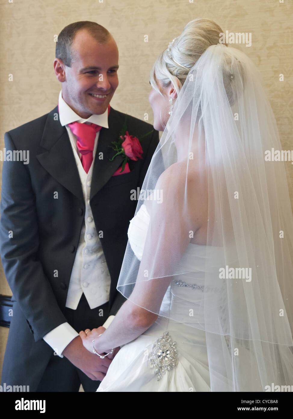 A newly married bride and groom share a quiet moment together on their ...