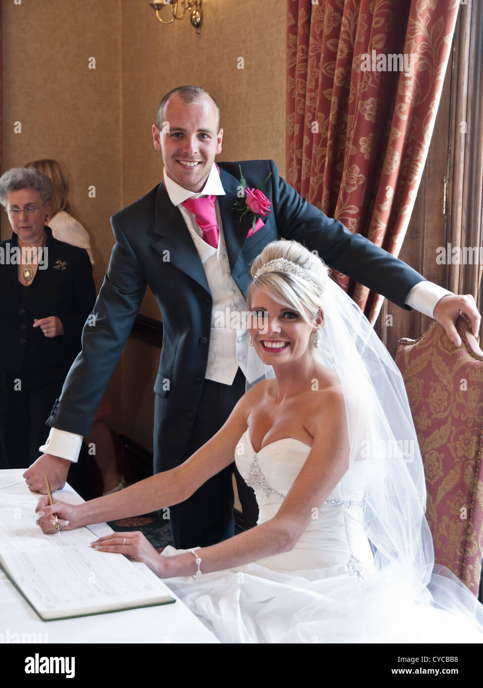 Couple signing a marriage register hi-res stock photography and images ...
