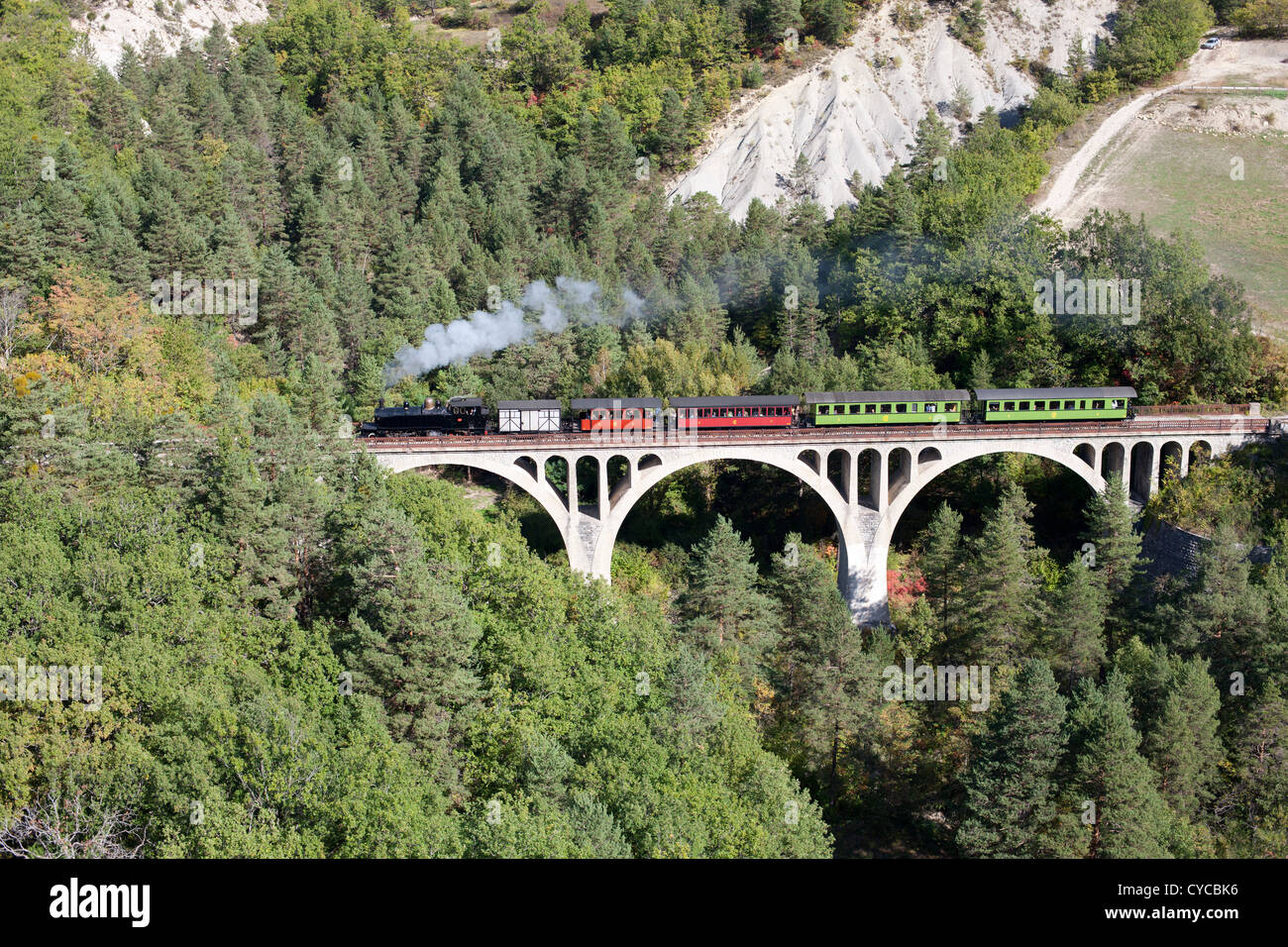 AERIAL VIEW. Historic and touristic steam train on a viaduct. Train des ...