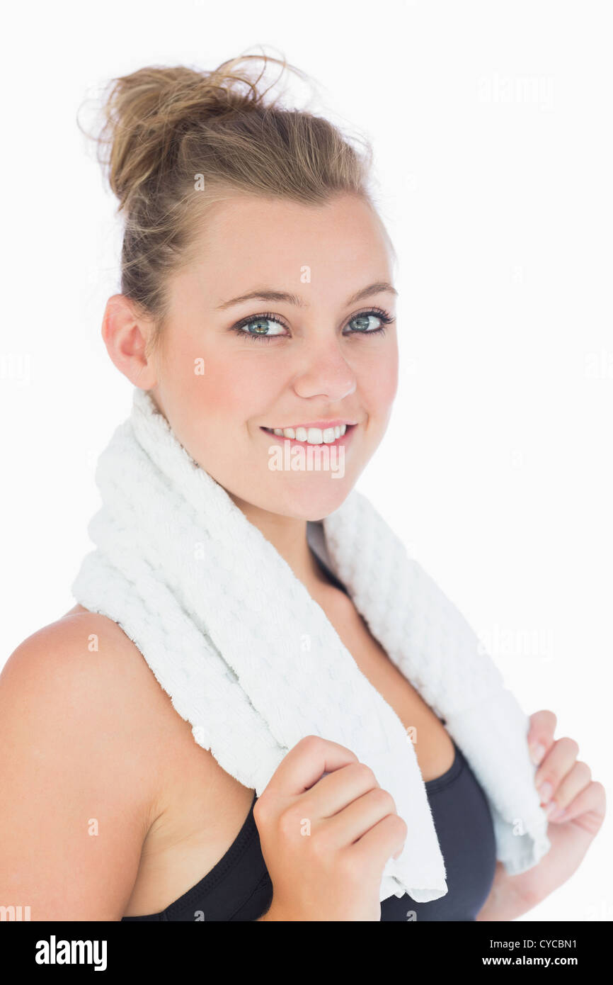 Woman standing and smiling with towel over shoulders Stock Photo - Alamy