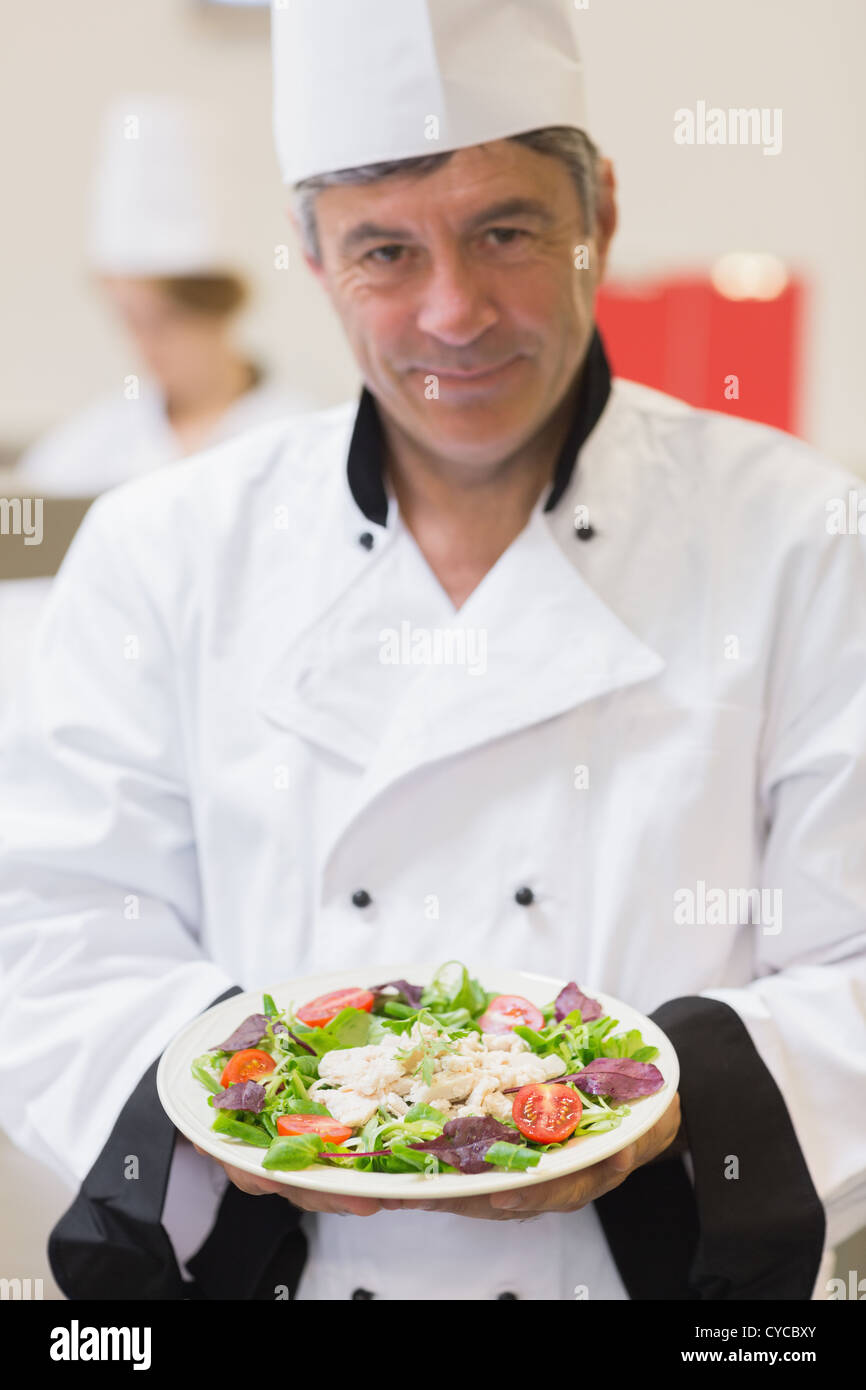 Cheerful chef presenting his salad Stock Photo - Alamy
