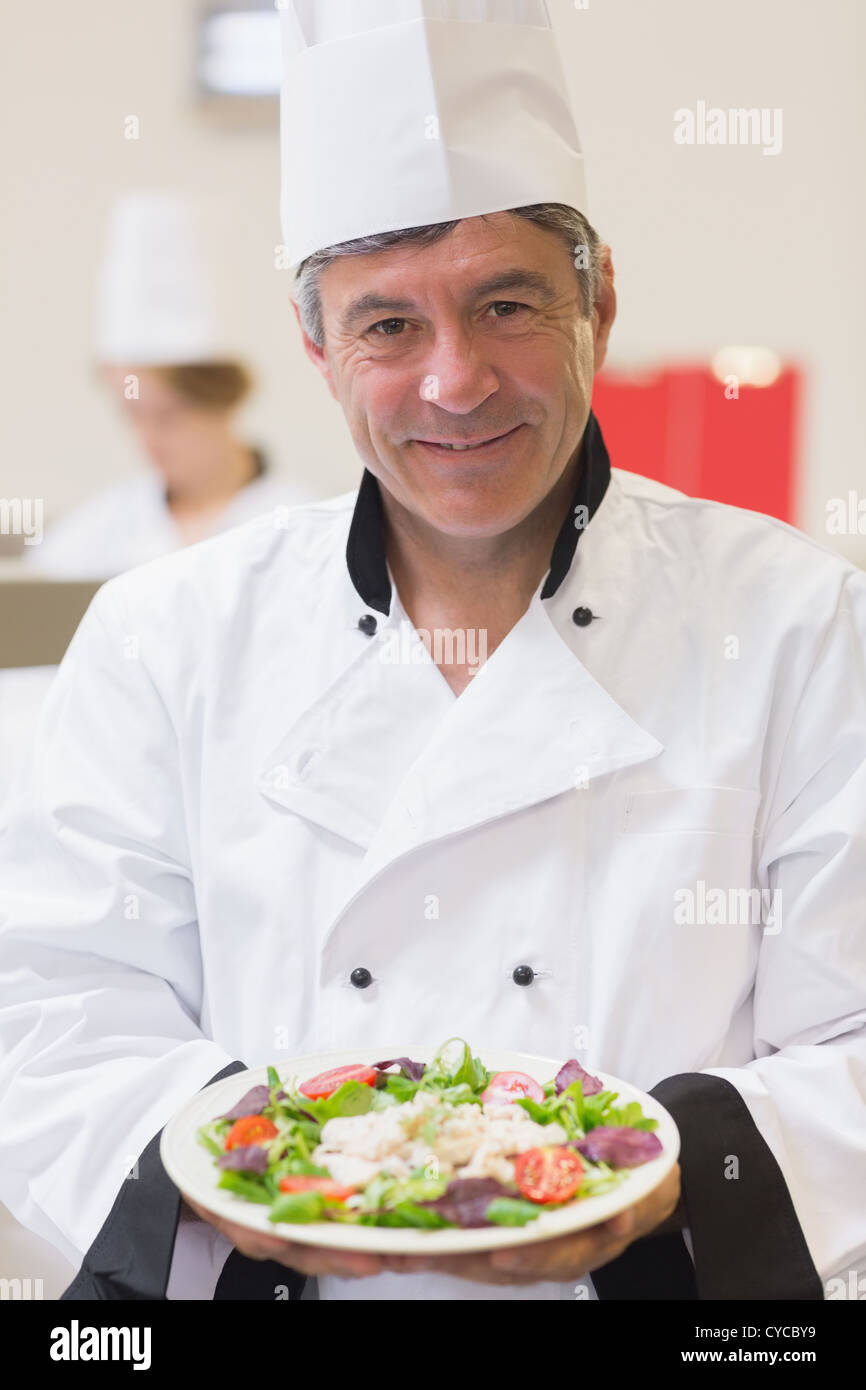 Smiling chef showing his salad Stock Photo - Alamy