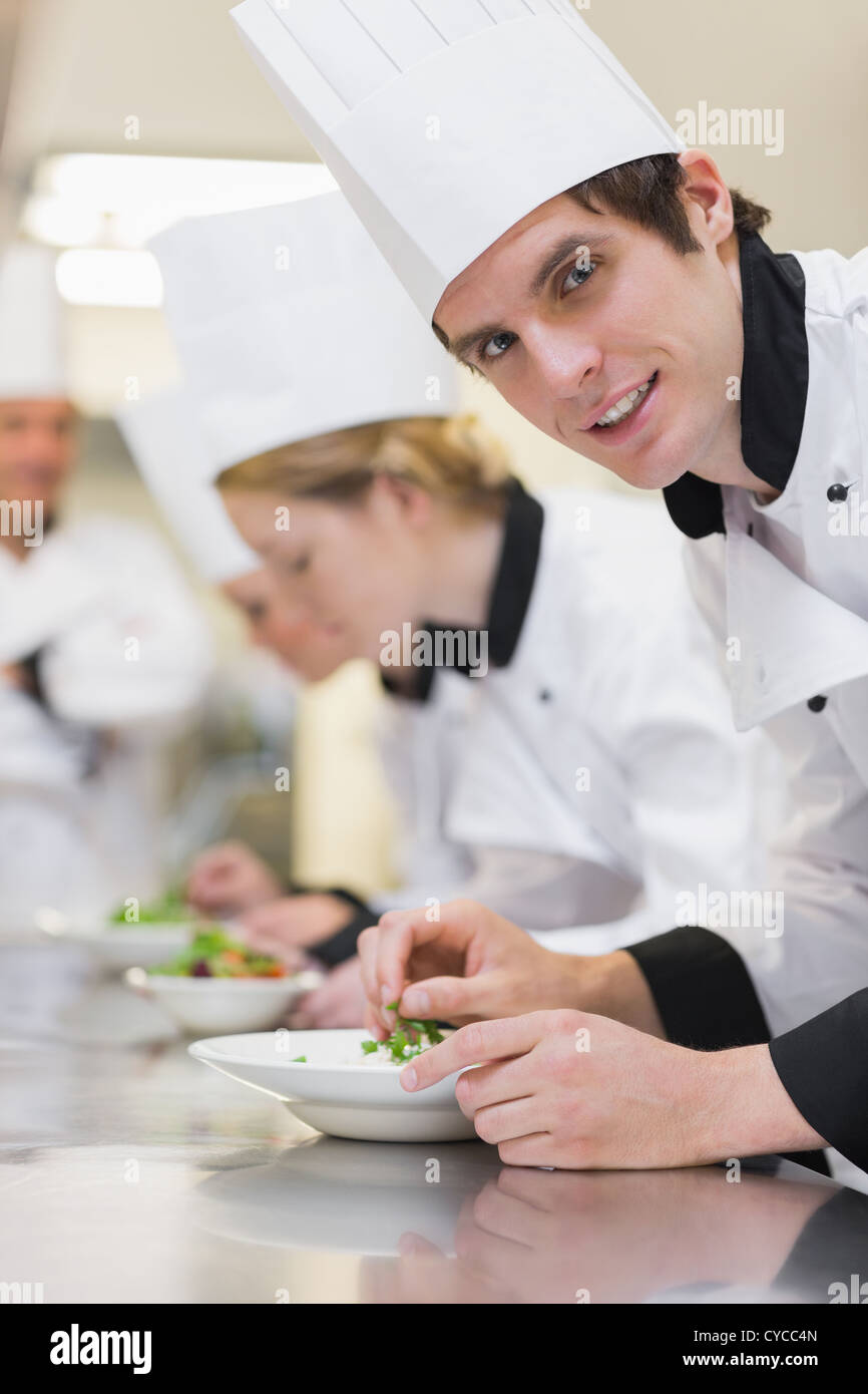 Chef looking up from preparing salad Stock Photo - Alamy