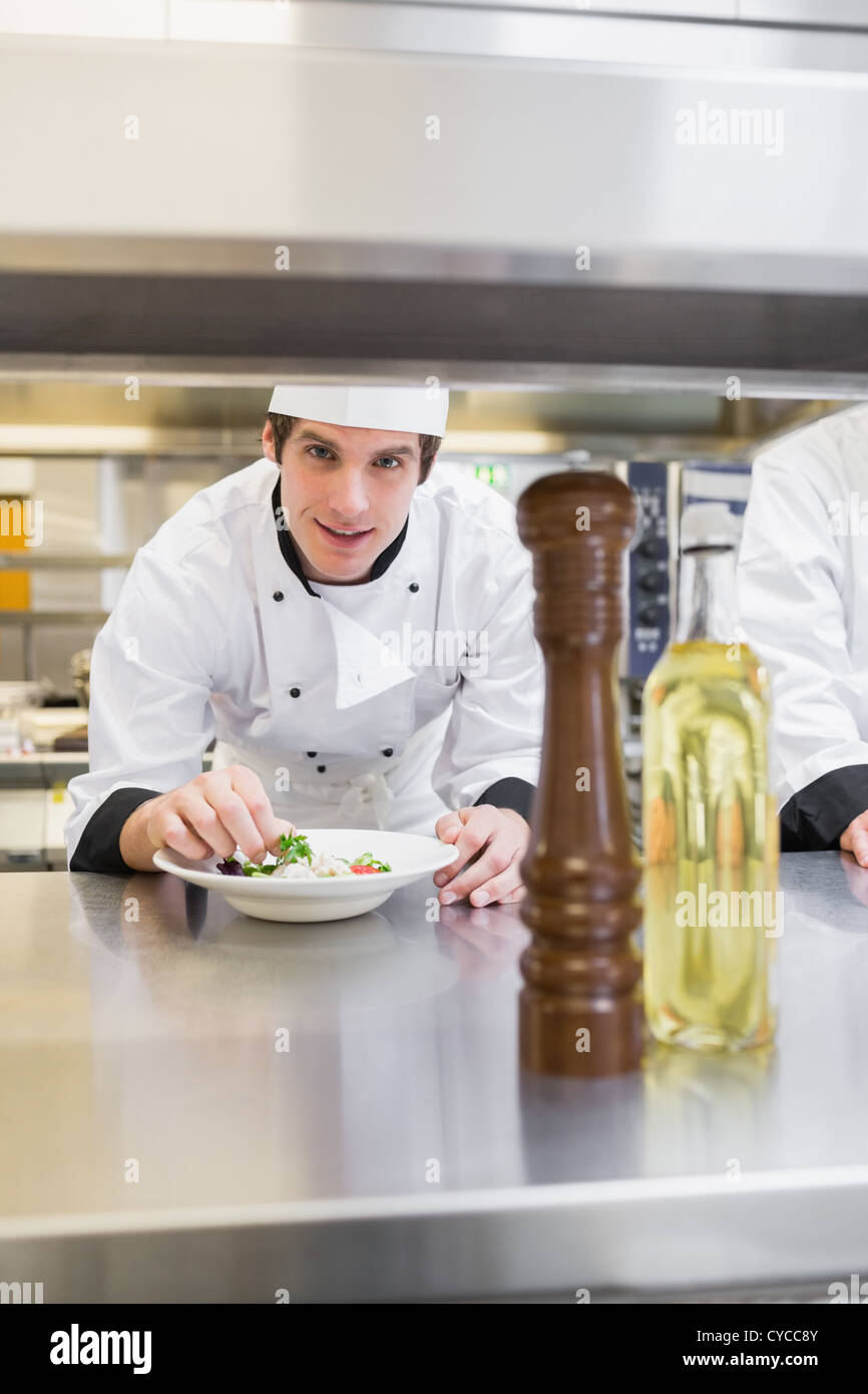 Chef looking up from garnishing salad Stock Photo - Alamy