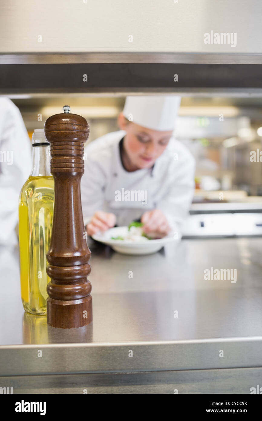 Pepper grinder and olive oil Stock Photo - Alamy