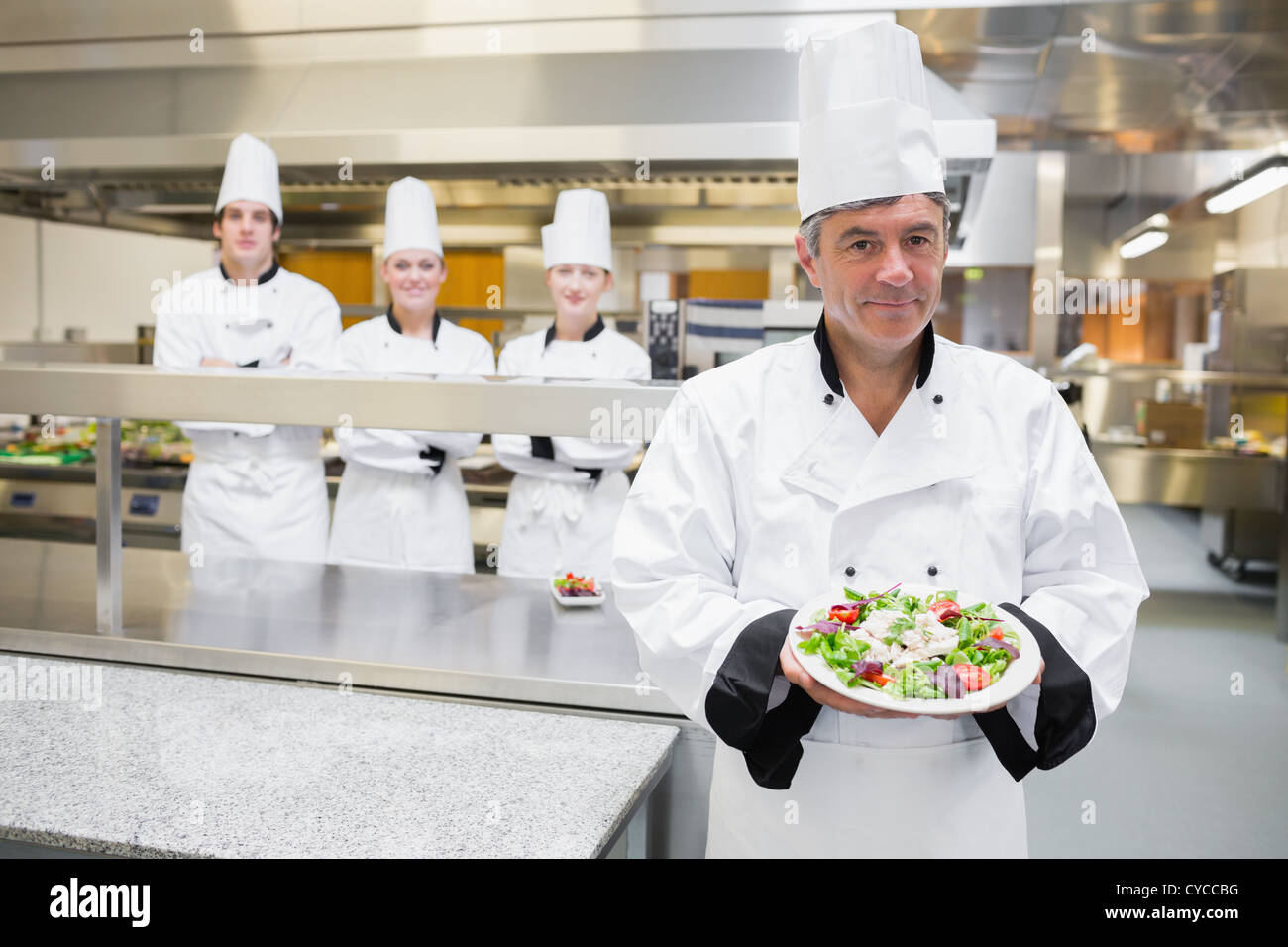 Head chef presenting salad Stock Photo - Alamy