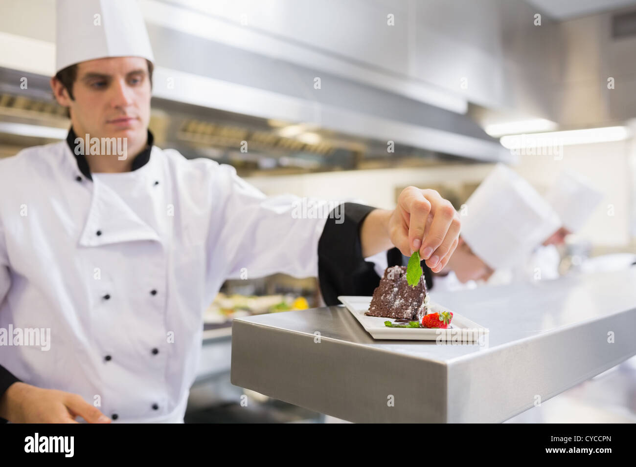 Chef garnishing his cake Stock Photo - Alamy