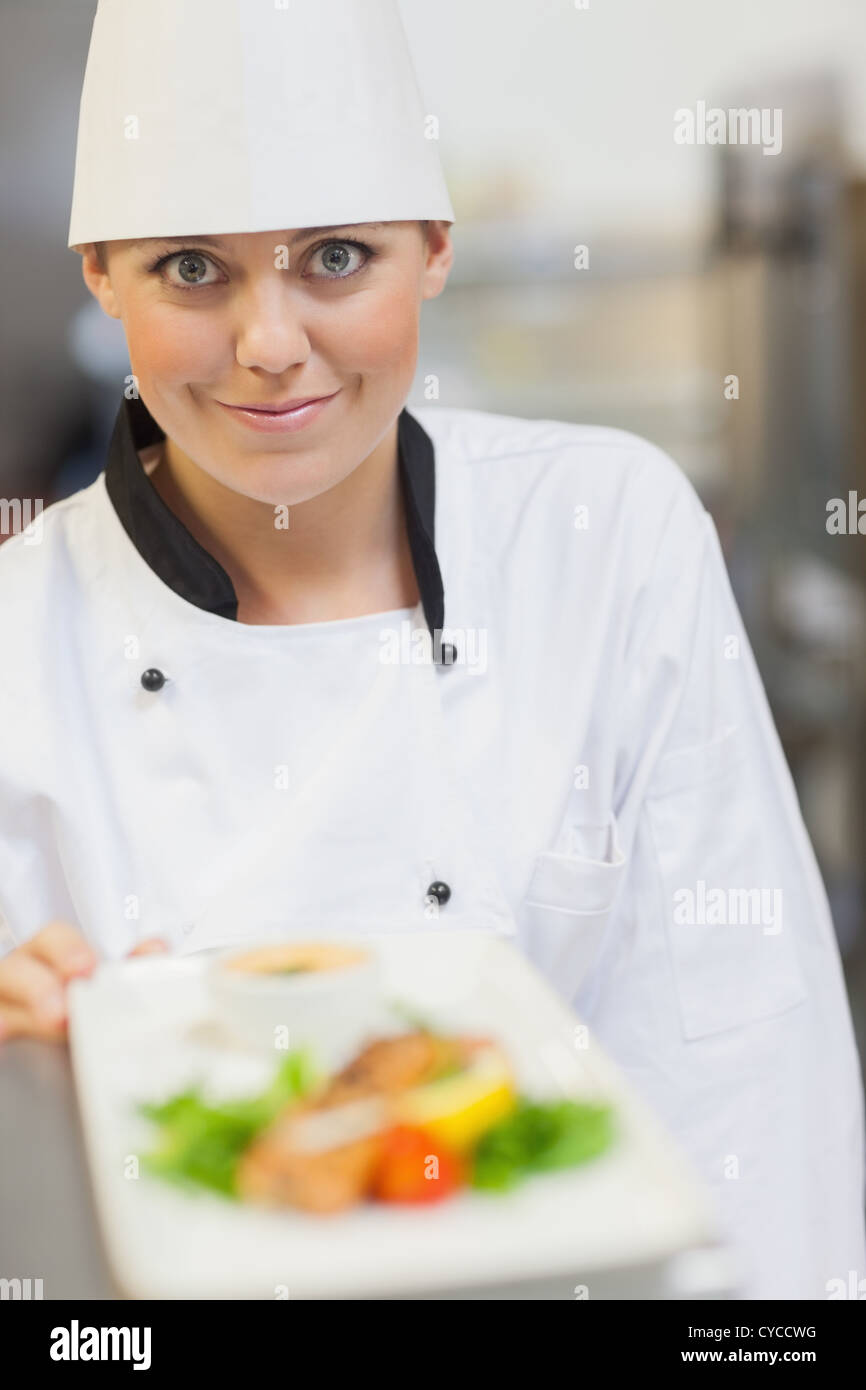 Smiling chef behind dinner plate Stock Photo - Alamy