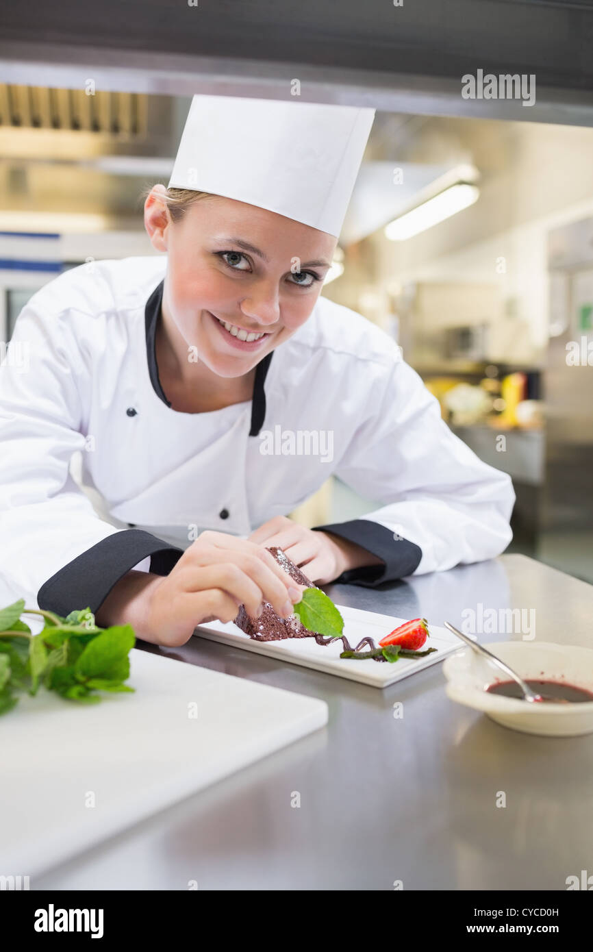 Smiling chef putting mint on the plate Stock Photo - Alamy