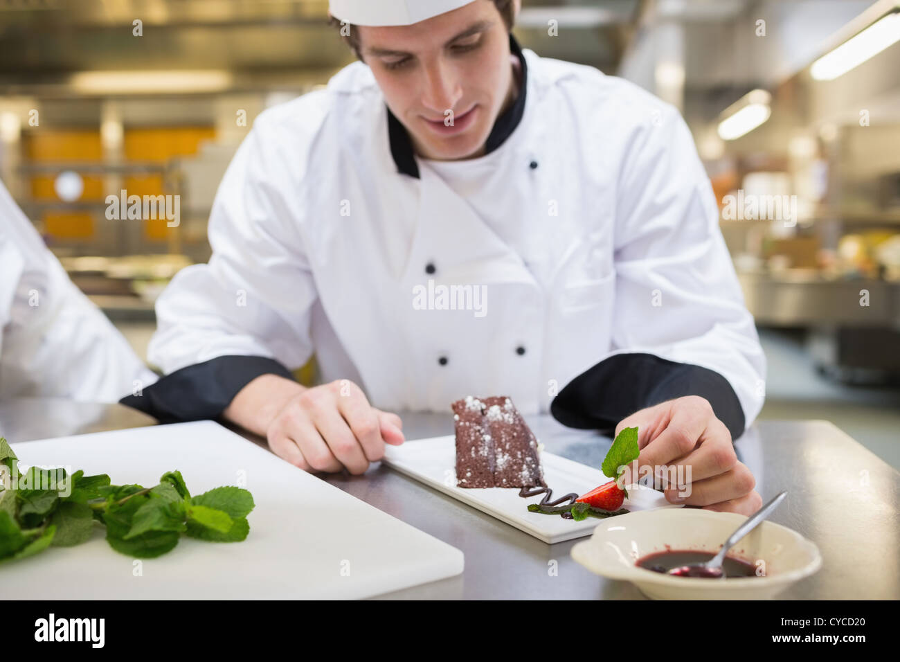 Chef putting mint leaf with his dessert Stock Photo - Alamy