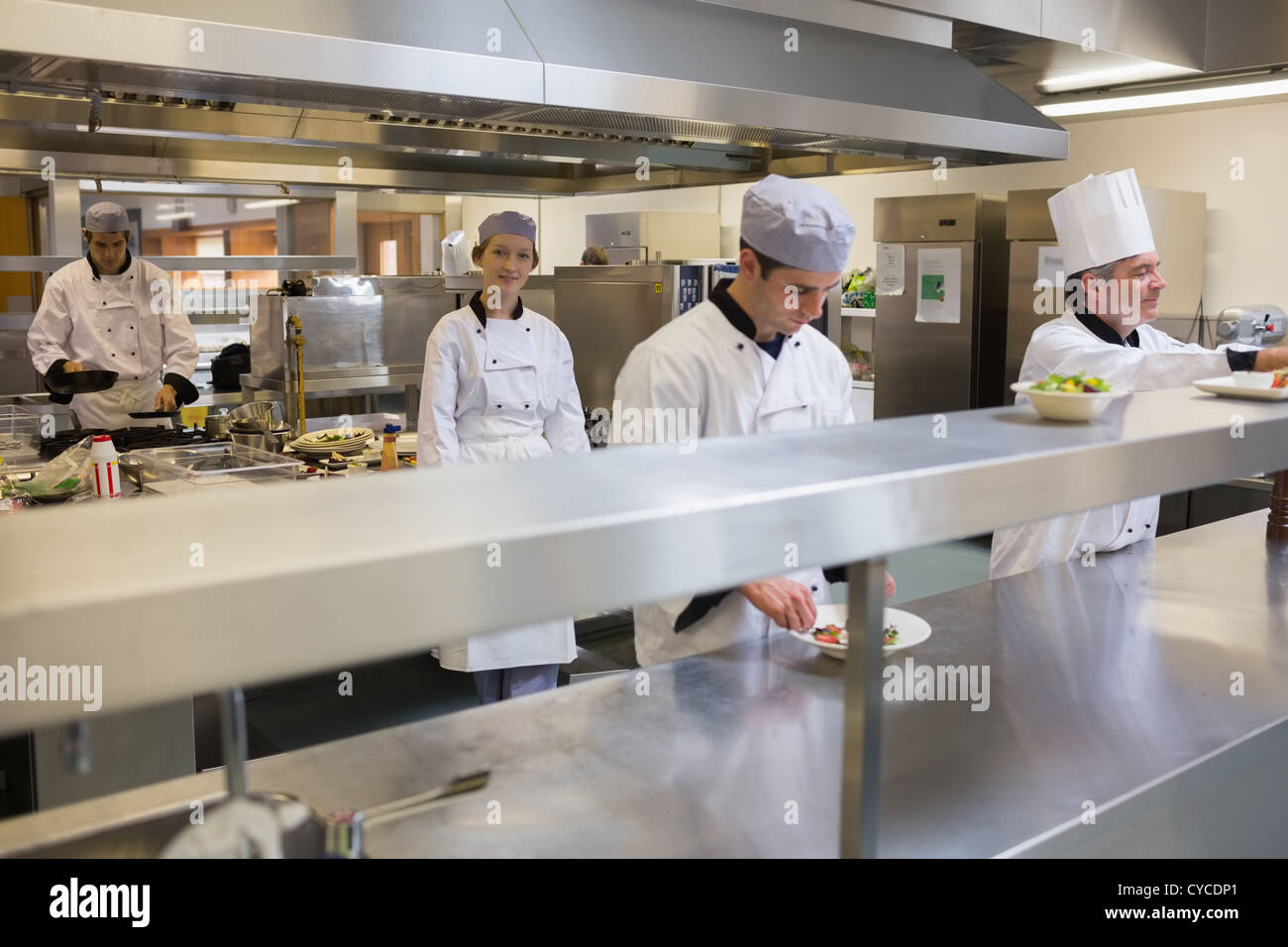 Restaurant kitchen with Chef's cooking Stock Photo - Alamy
