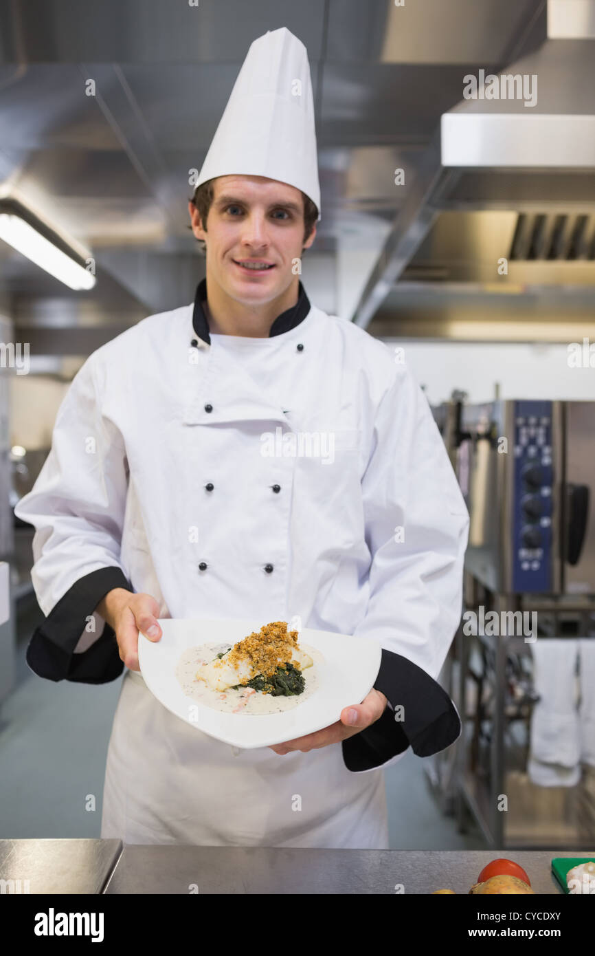 Smiling chef presenting his plate Stock Photo - Alamy