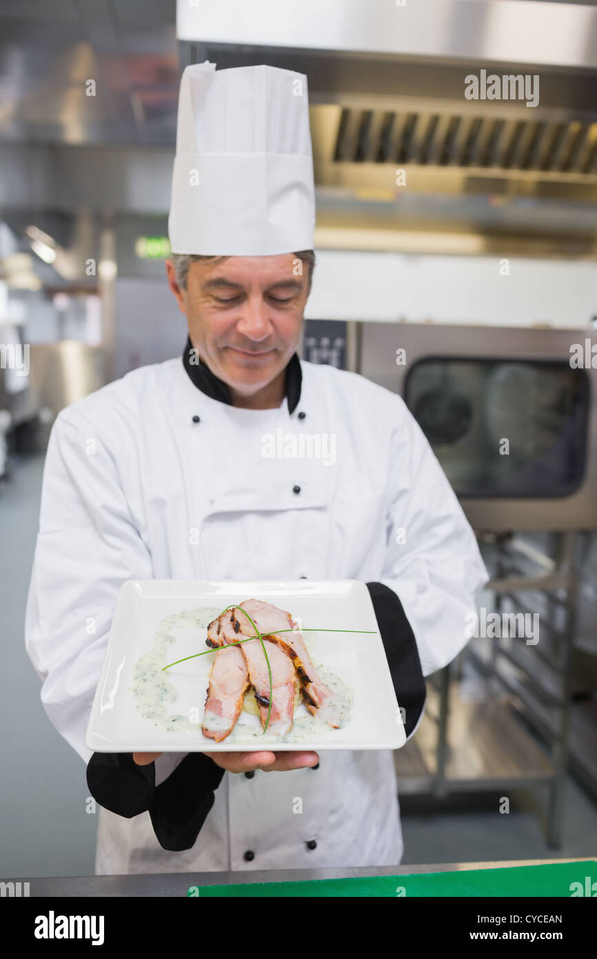 Chef looking at his dish Stock Photo - Alamy