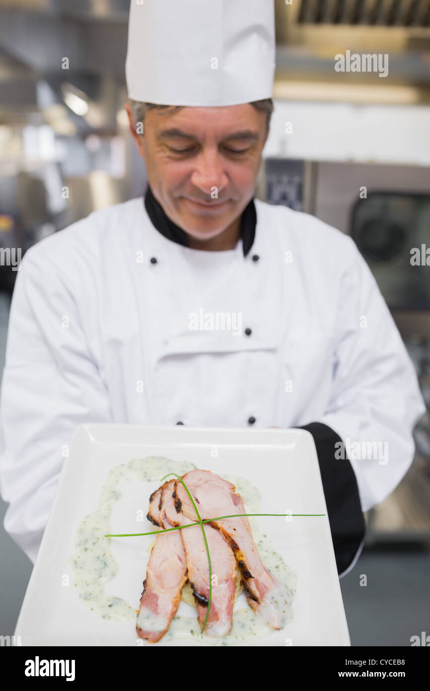 Cook presenting a meal Stock Photo - Alamy
