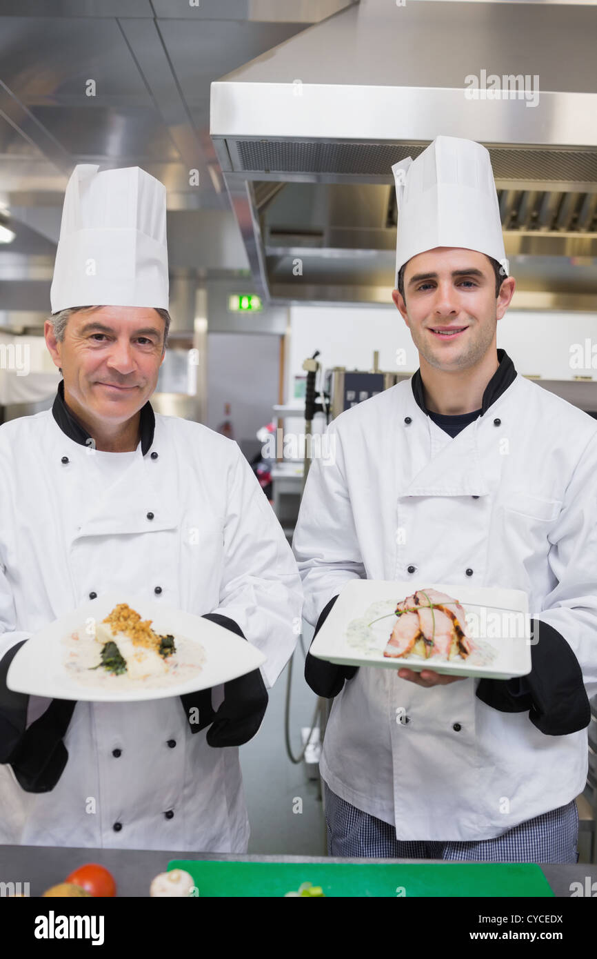 Smiling Chef's presenting their dishes Stock Photo - Alamy