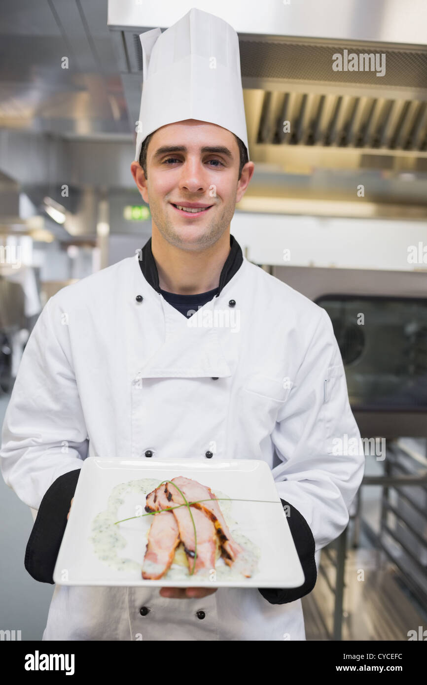 Smiling cook holding his meal Stock Photo - Alamy
