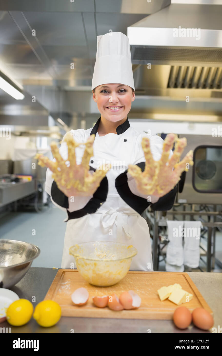 Baker showing her sticky hands Stock Photo - Alamy