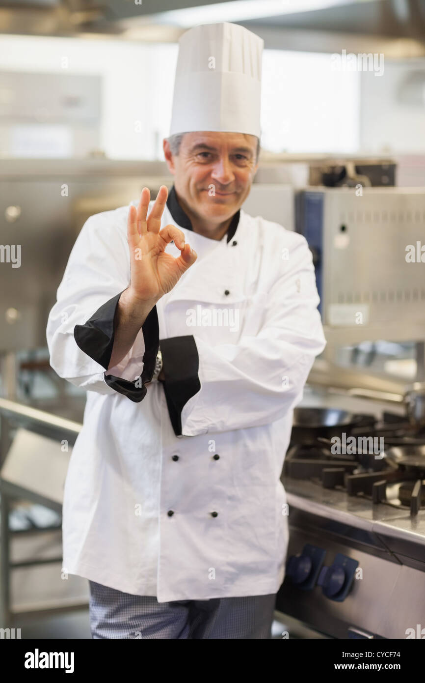Chef giving ok symbol by the stove Stock Photo - Alamy