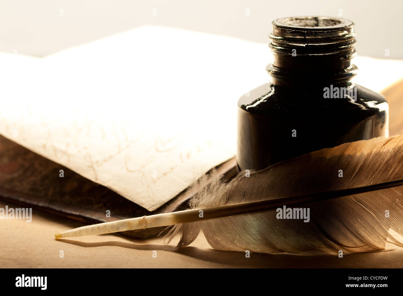 Old book with feather and inkpot Stock Photo - Alamy