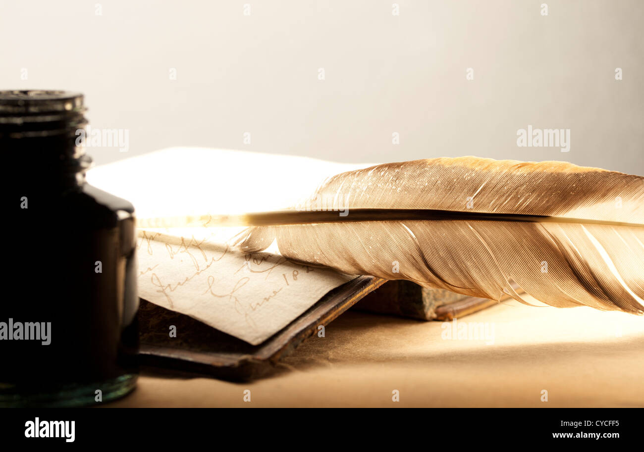 Old book with feather and inkpot Stock Photo - Alamy