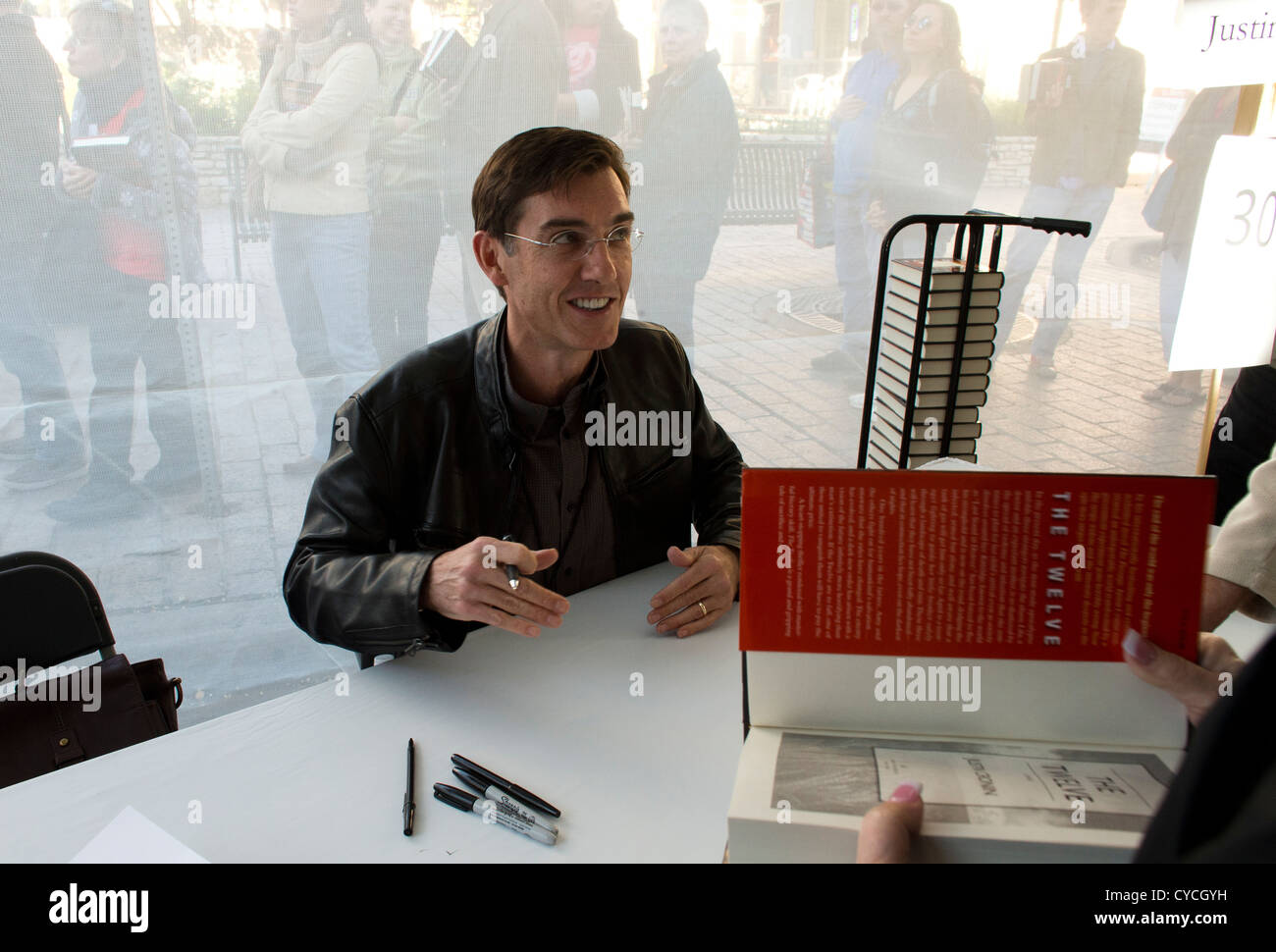 Author Justin Cronin signs copies of his books for fans at the Texas ...
