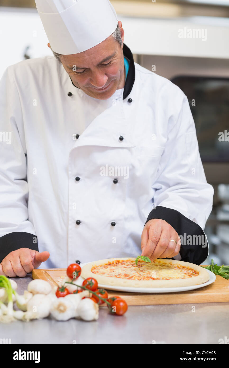 Happy chef making pizza Stock Photo - Alamy