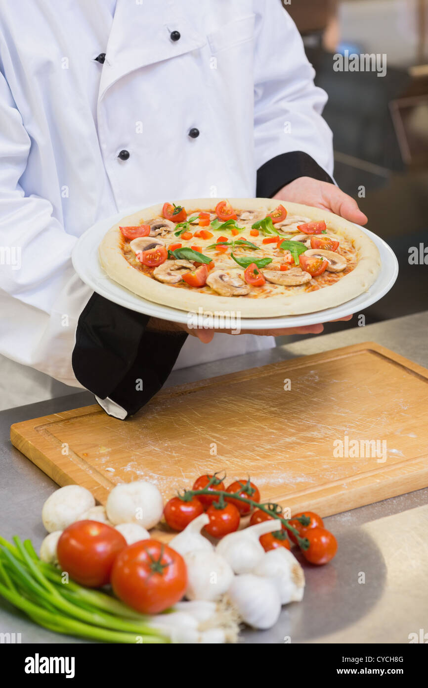 Chef holding mushroom pizza Stock Photo - Alamy