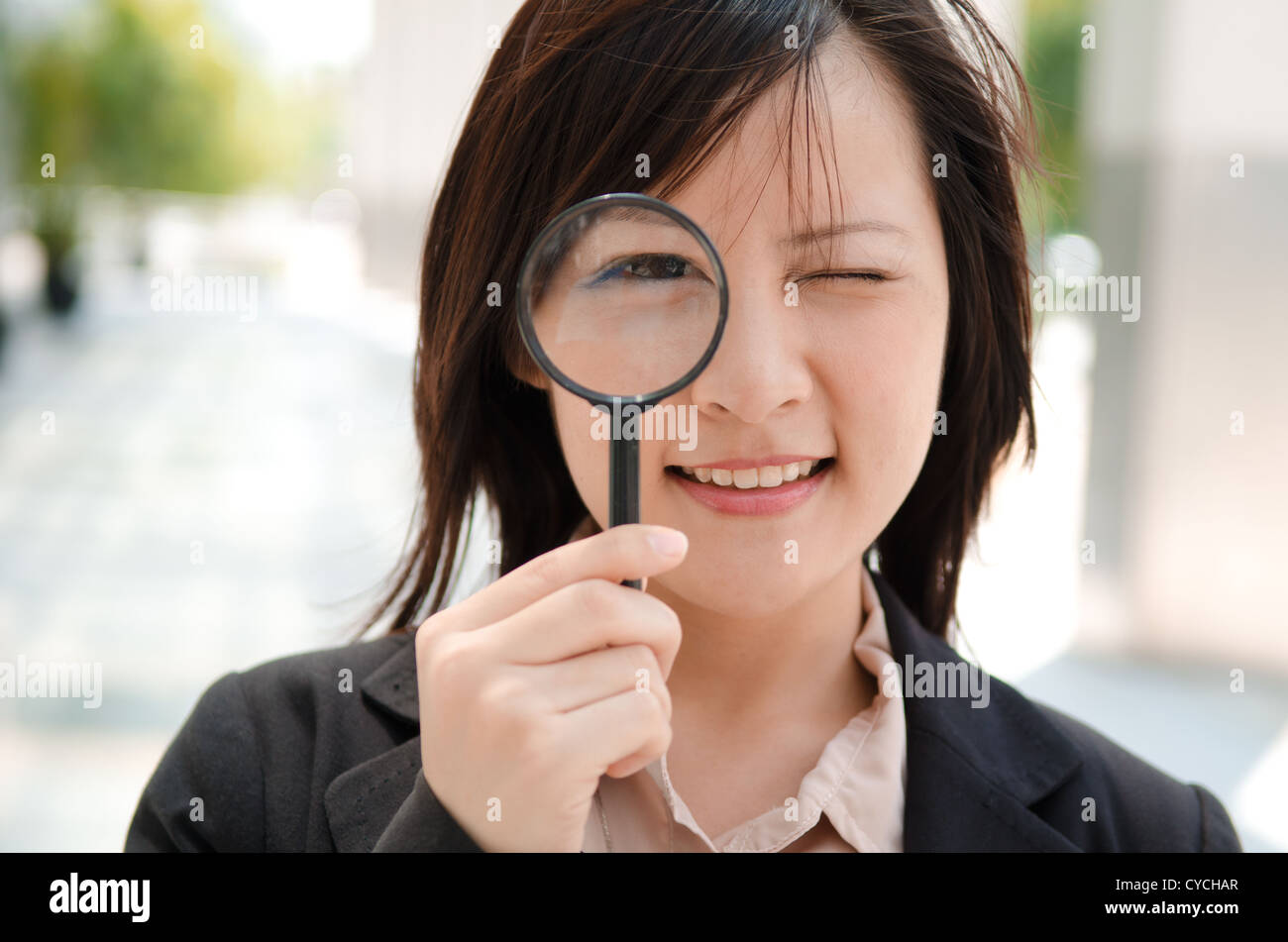 asian business girl with magnifying glass, smiling Stock Photo - Alamy
