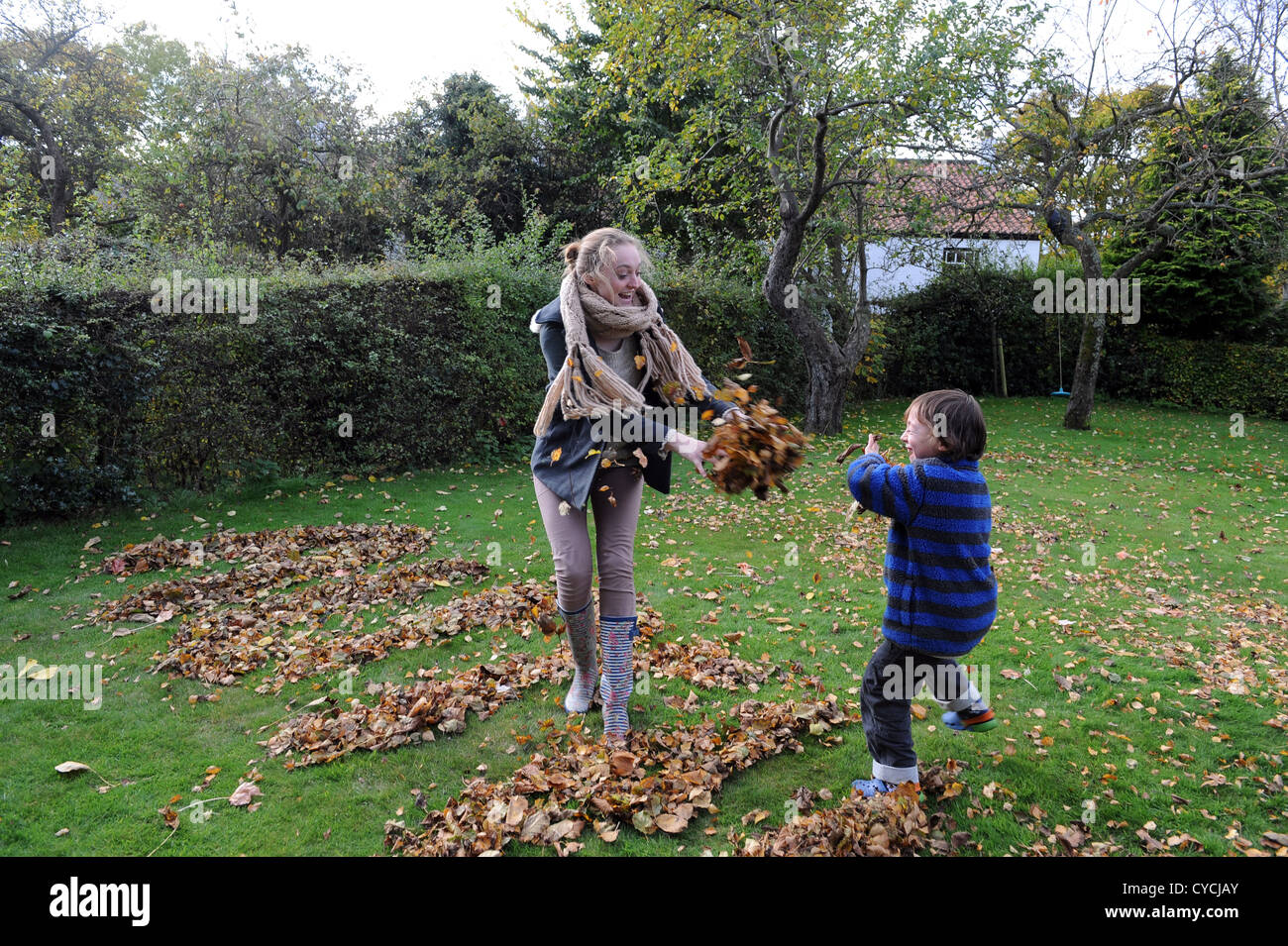 Children having a leaf fight in the garden in north yorkshire Stock ...