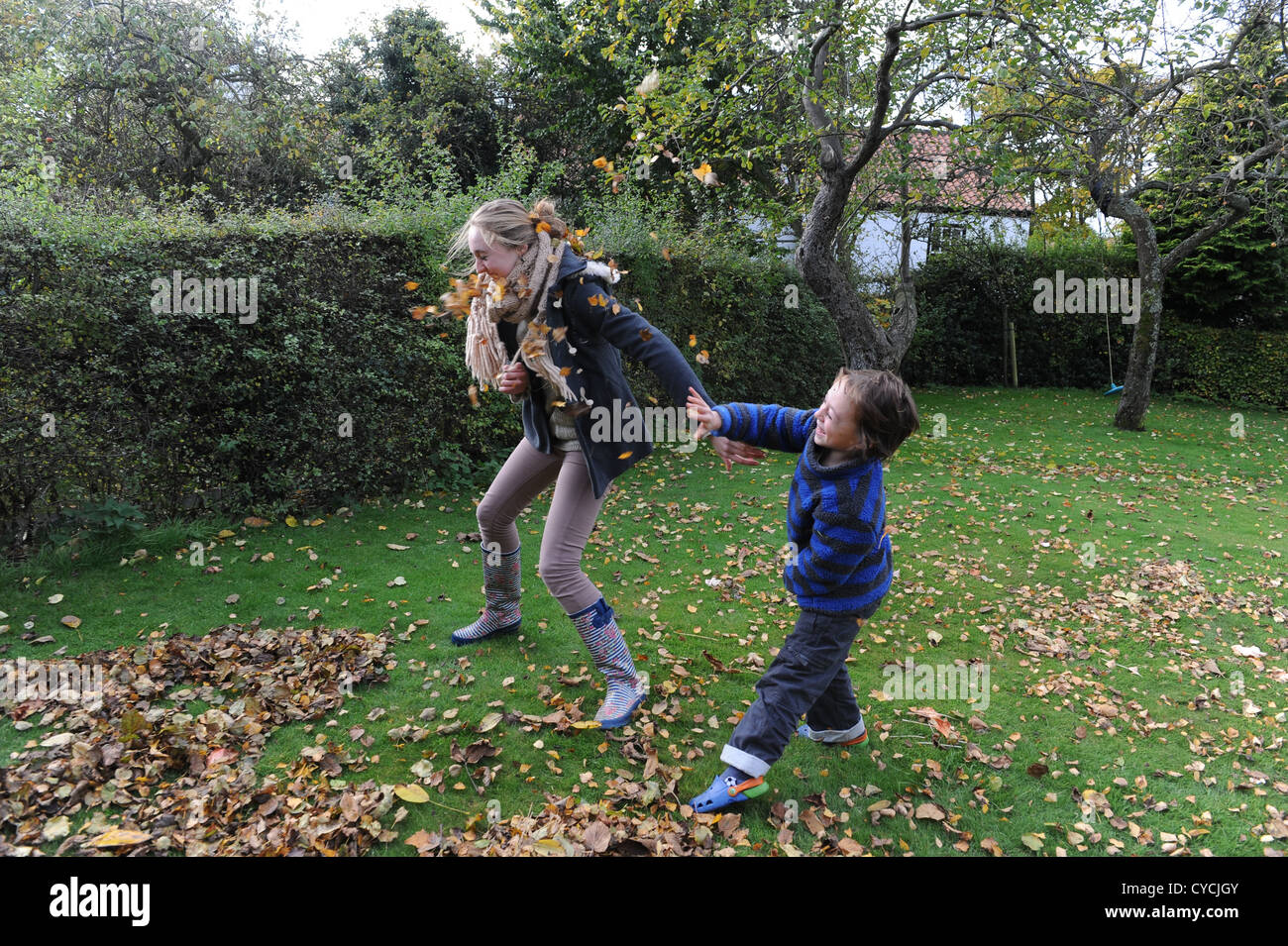 Children having a leaf fight in the garden in north yorkshire Stock ...