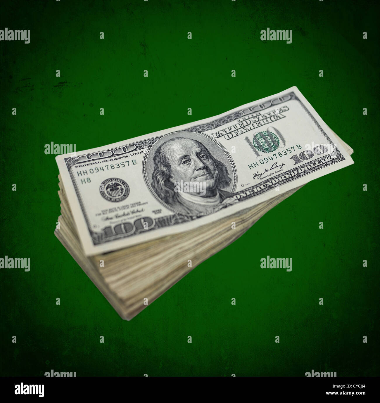 Stack of dollars on grunge green background Stock Photo - Alamy