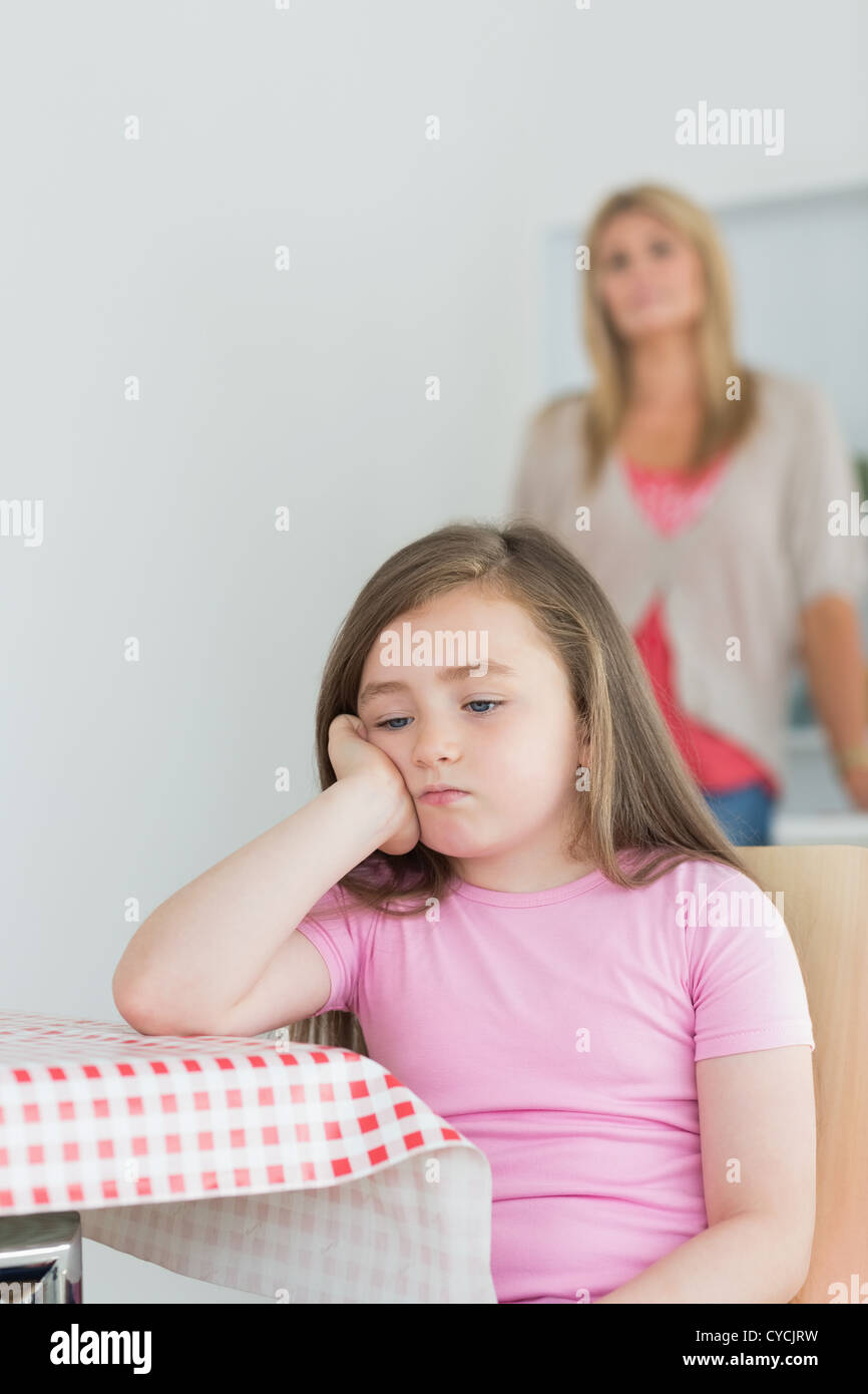 Little girl sitting looking exasperated Stock Photo - Alamy