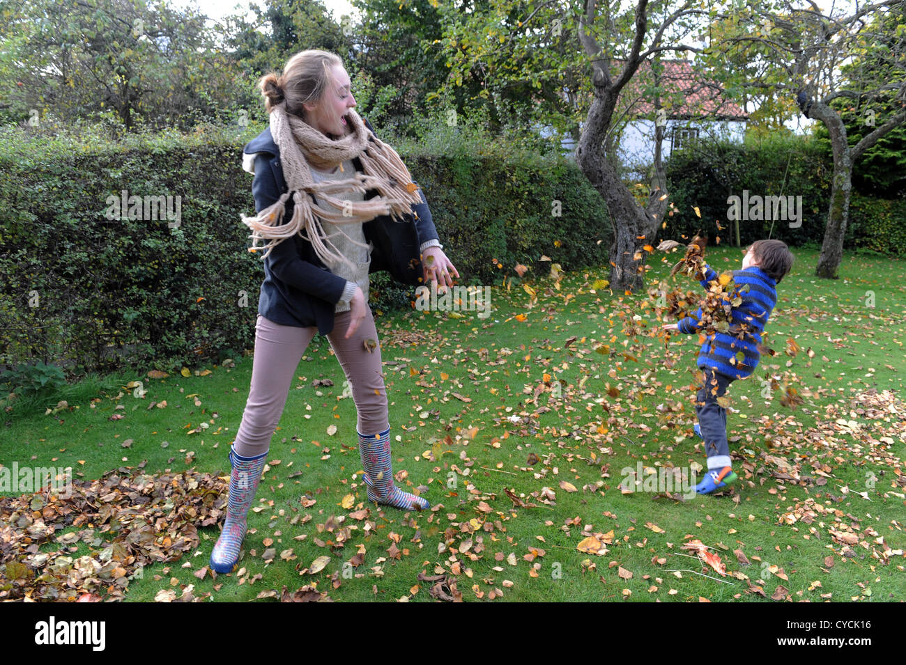 Children having a leaf fight in the garden in north yorkshire Stock ...