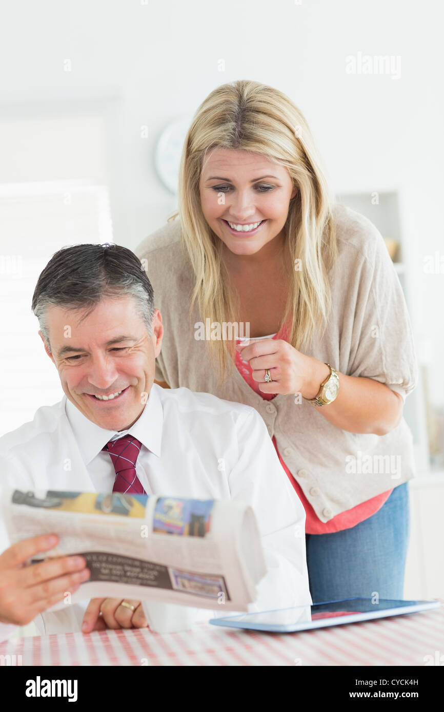 Couple reading a newspaper together Stock Photo - Alamy