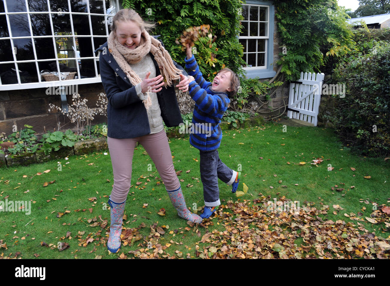 Children having a leaf fight in the garden in north yorkshire Stock ...