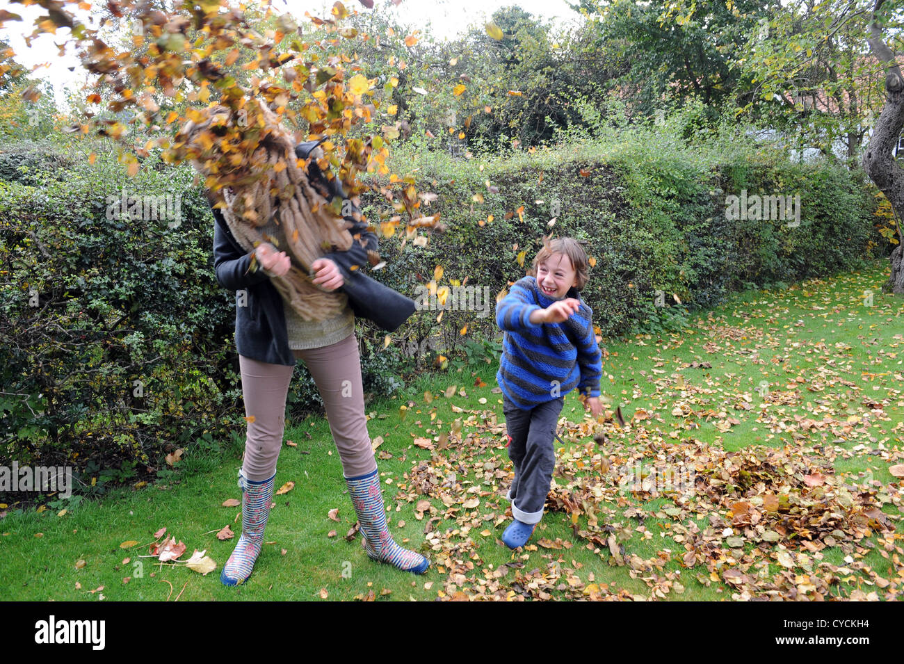 Children having a leaf fight in the garden in north yorkshire Stock ...