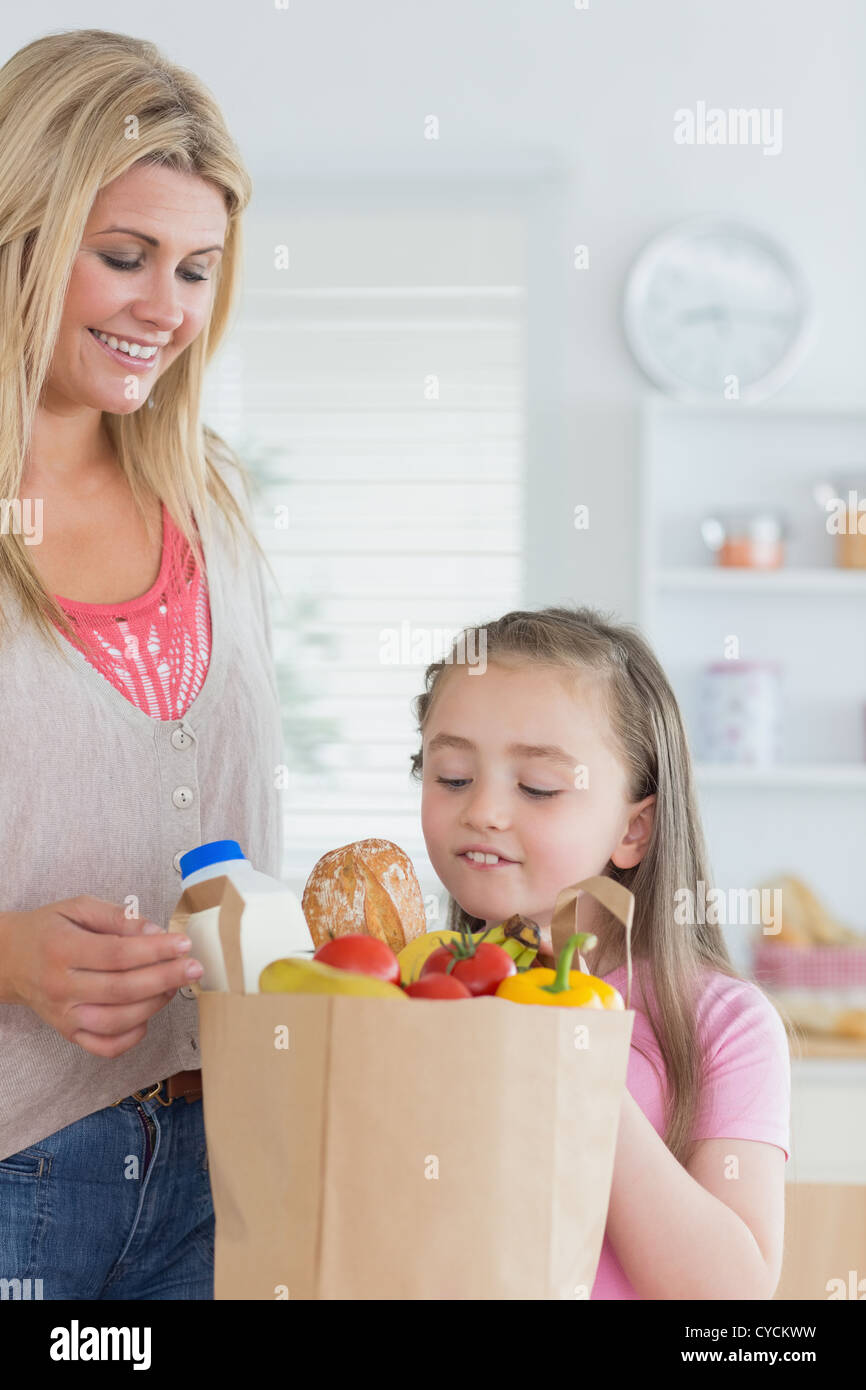 Child looking into grocery bag Stock Photo - Alamy
