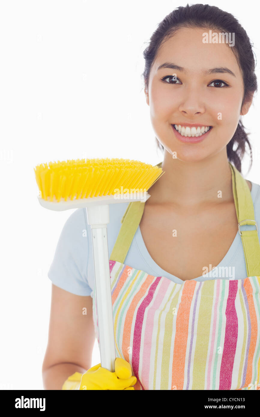 Smiling woman with broom Stock Photo - Alamy