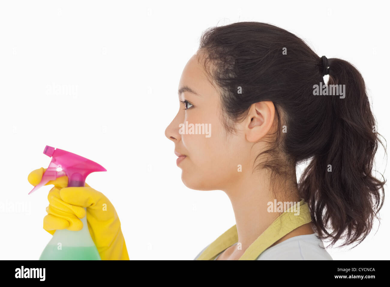 Woman spraying cleaning product Stock Photo - Alamy