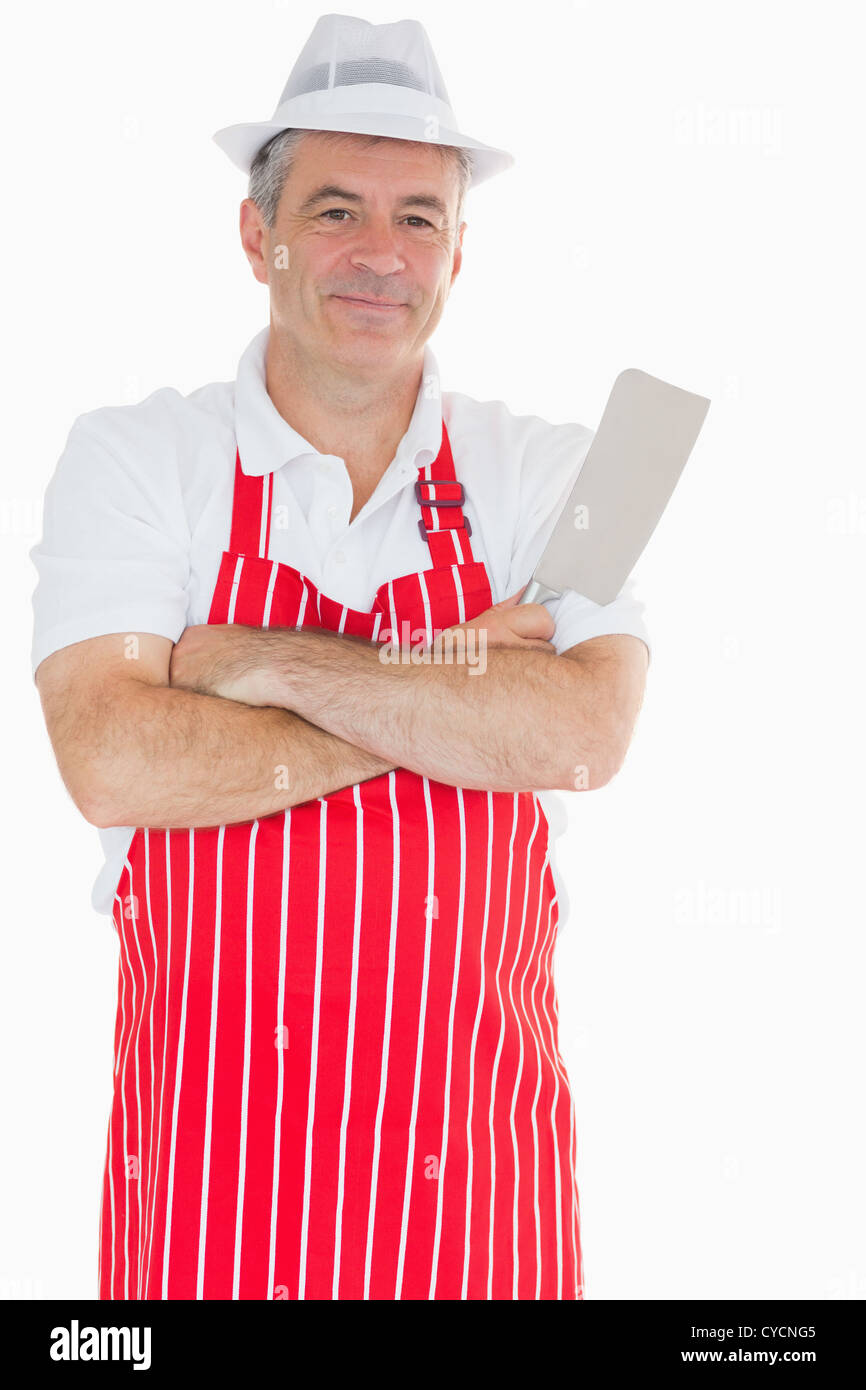 Butcher with arms crossed holding meat cleaver Stock Photo - Alamy