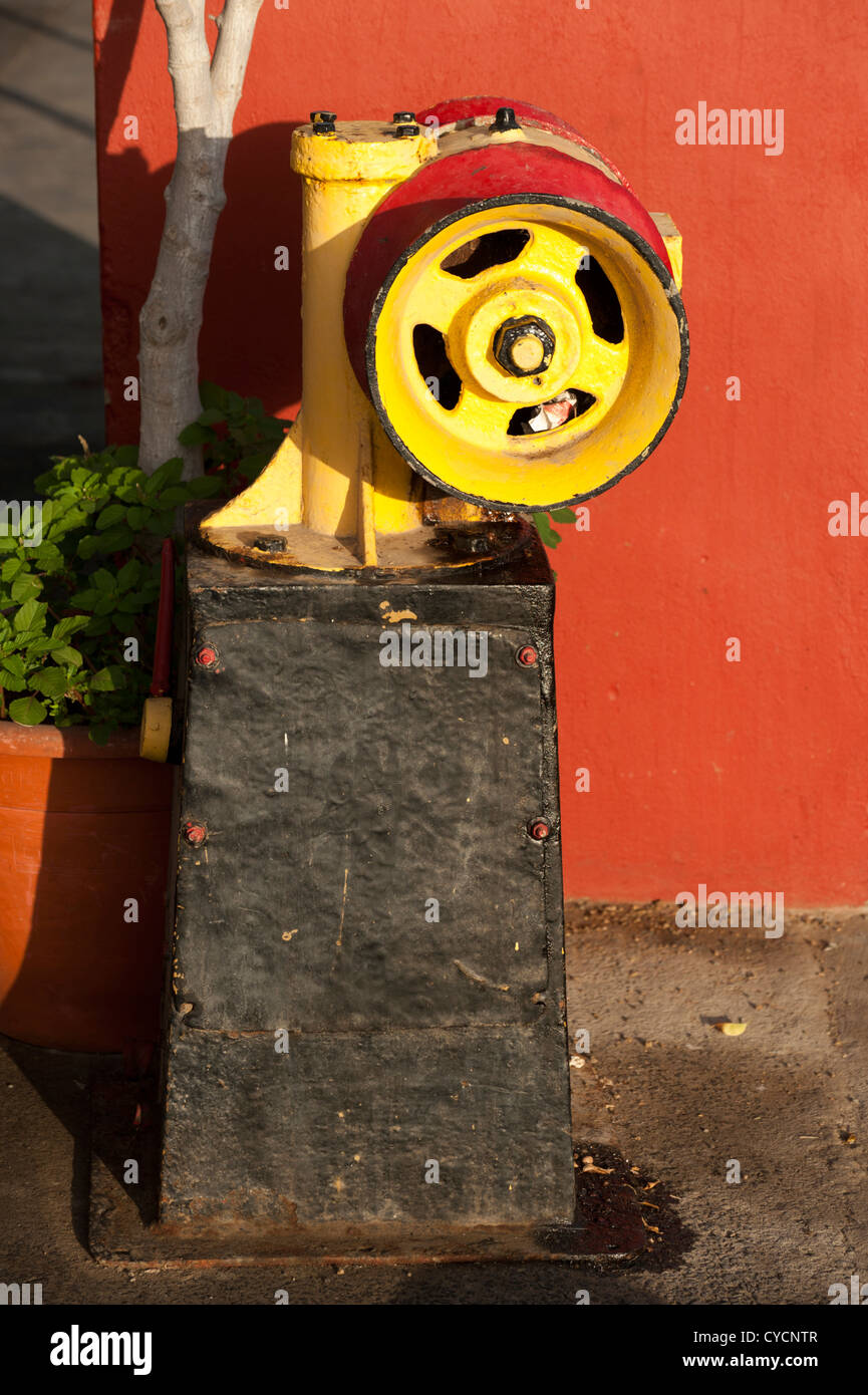 A brightly pained winch wheel at the harbour Puerto de Mogan Gran ...