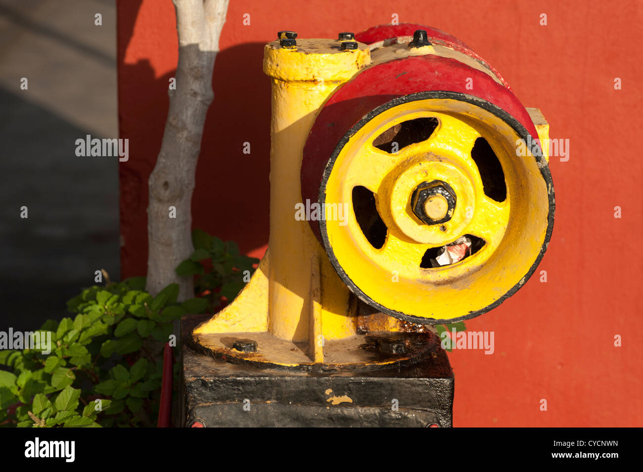 A brightly pained winch wheel at the harbour Puerto de Mogan Gran ...