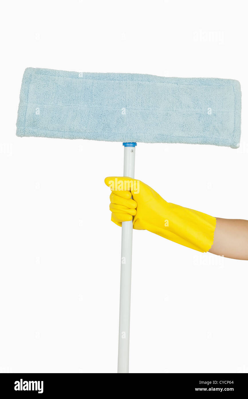 Female hand in glove holding mop Stock Photo - Alamy