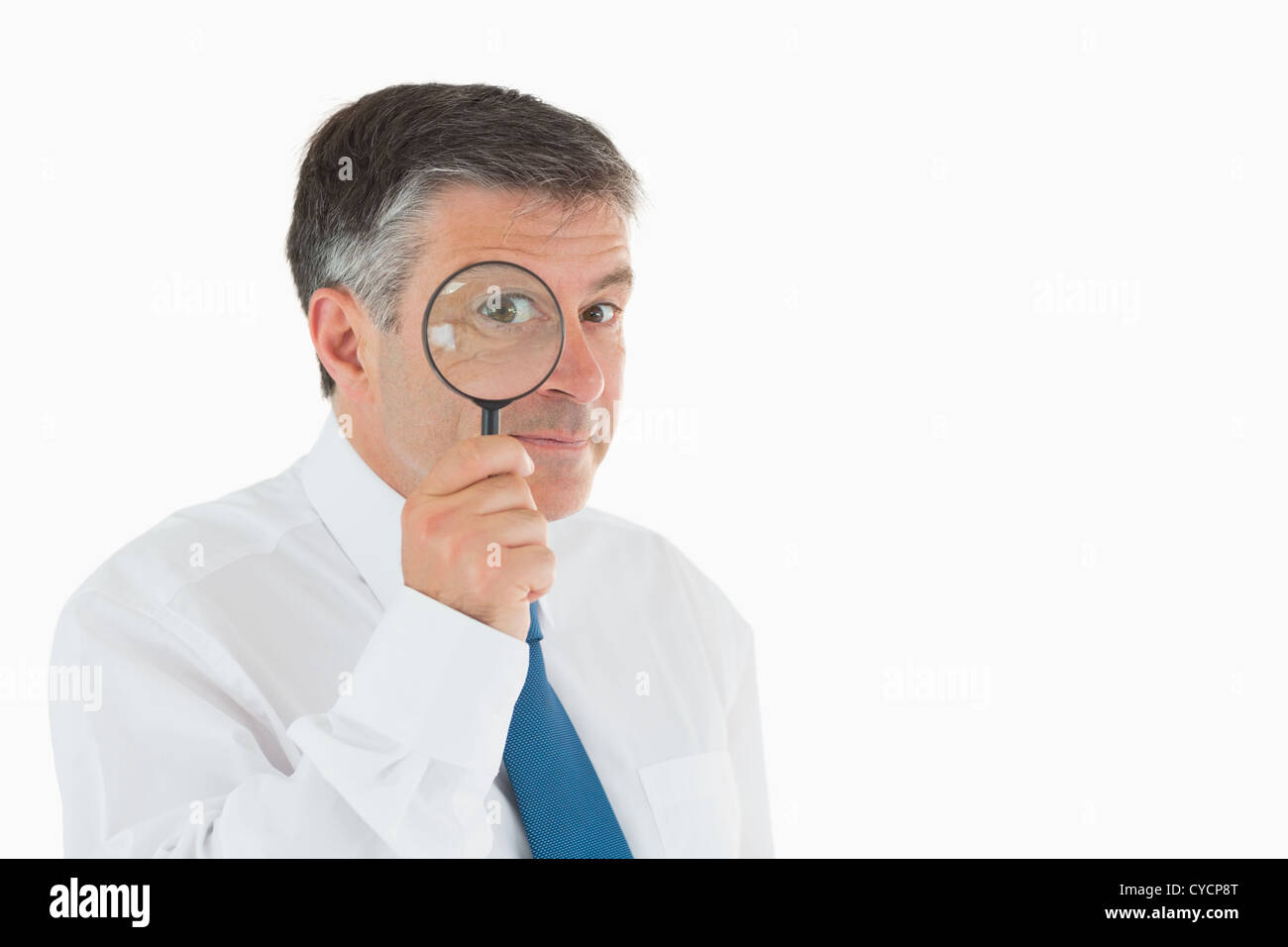 Businessman looking through magnifying glass Stock Photo - Alamy