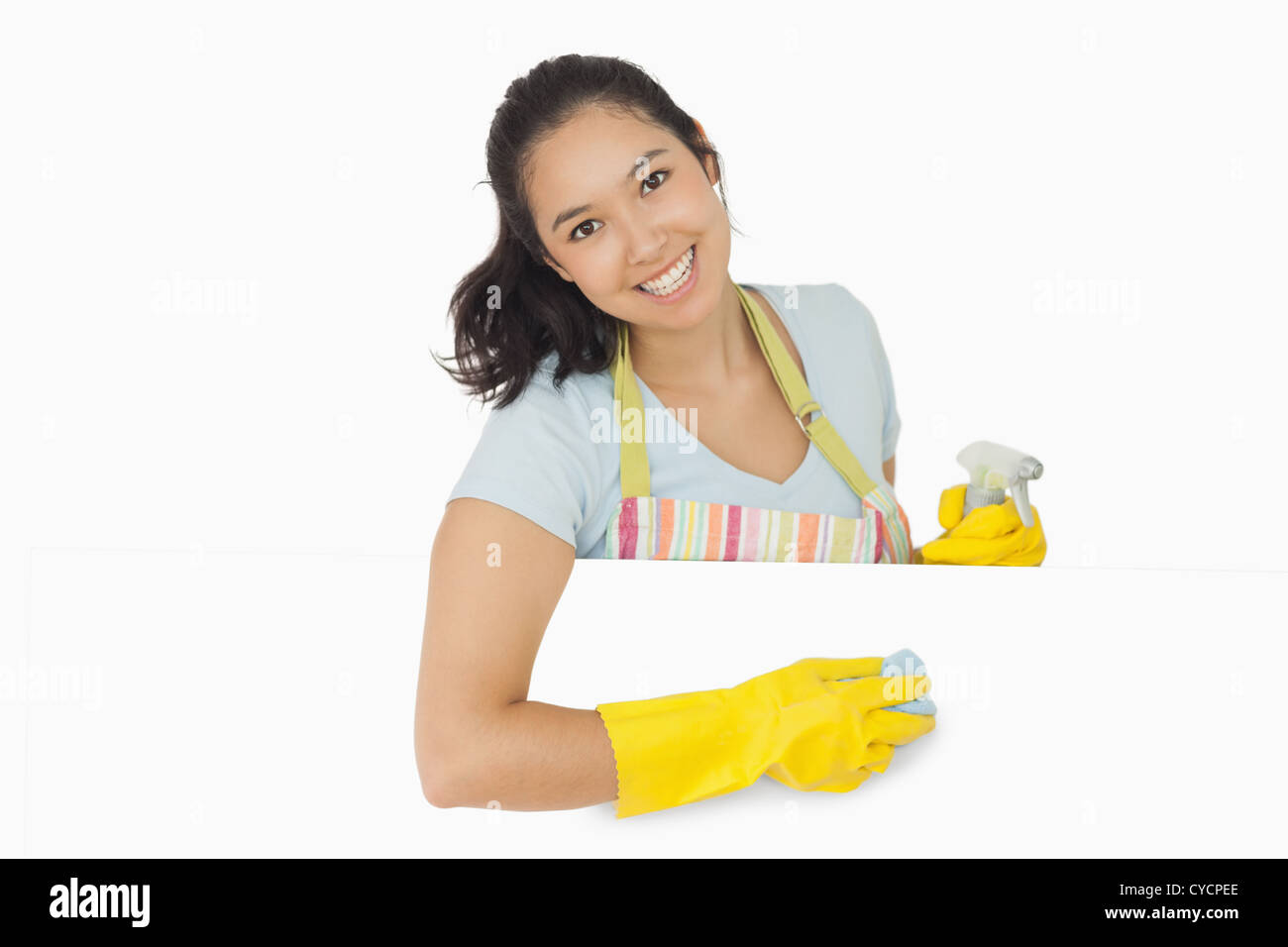 Happy woman wiping white surface Stock Photo - Alamy