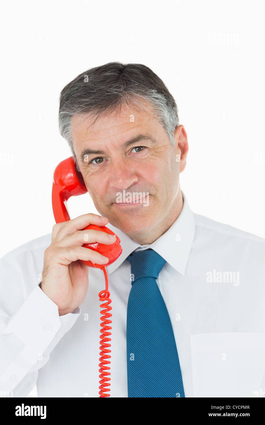Businessman using red phone Stock Photo - Alamy