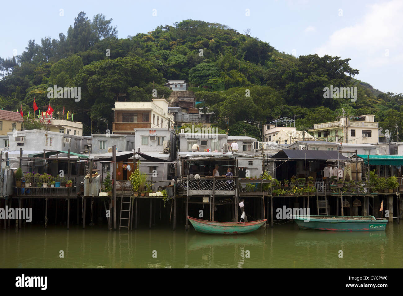 Elderly couple on the balcony of their house in Tai O fishing village ...
