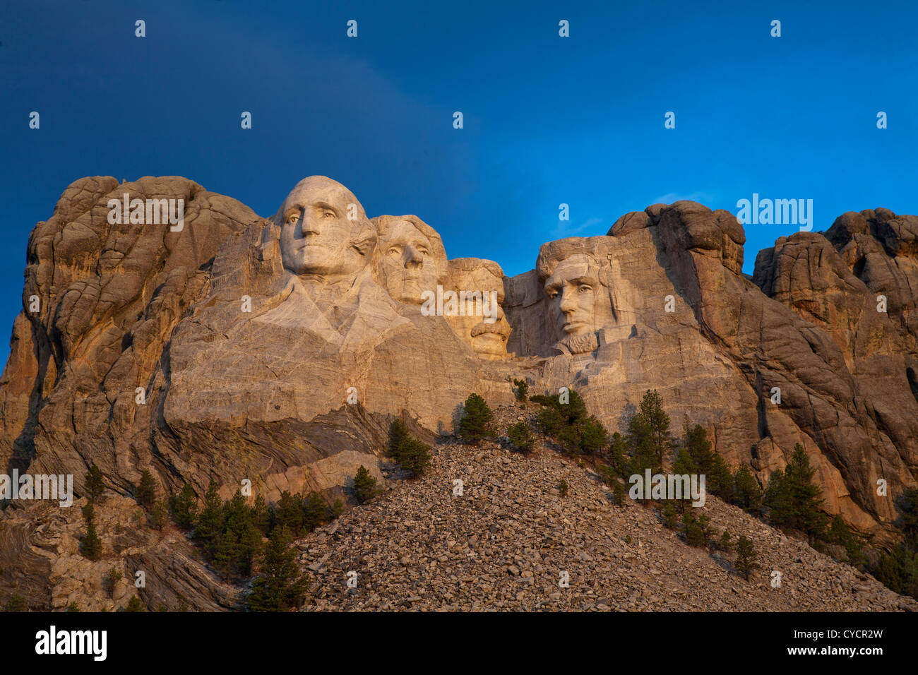 The granite faces of Mount Rushmore National Memorial at sunrise in ...